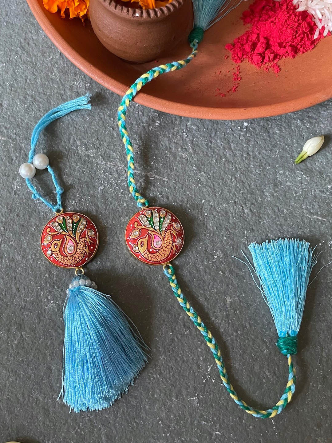 Buy Mitali Jain Set Of 2 Orange And Blue Tanjore Rakhi Lumba Set ...