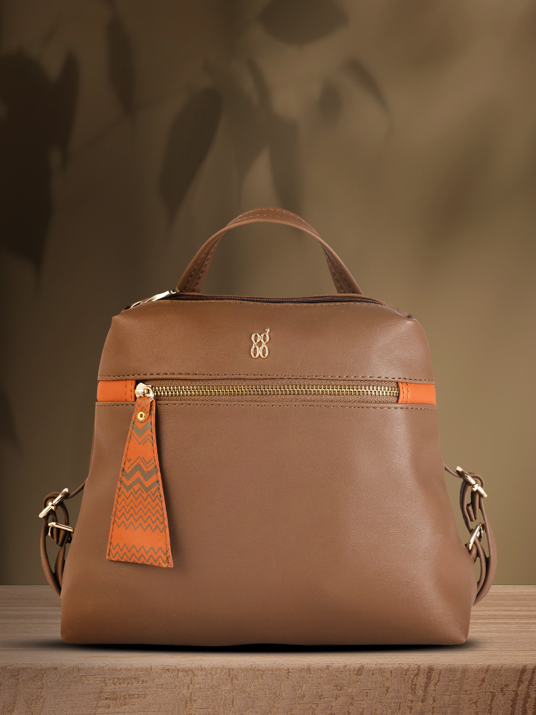 Buy Baggit Brown Solid Regular Structured Handheld Bag With Tasselled ...